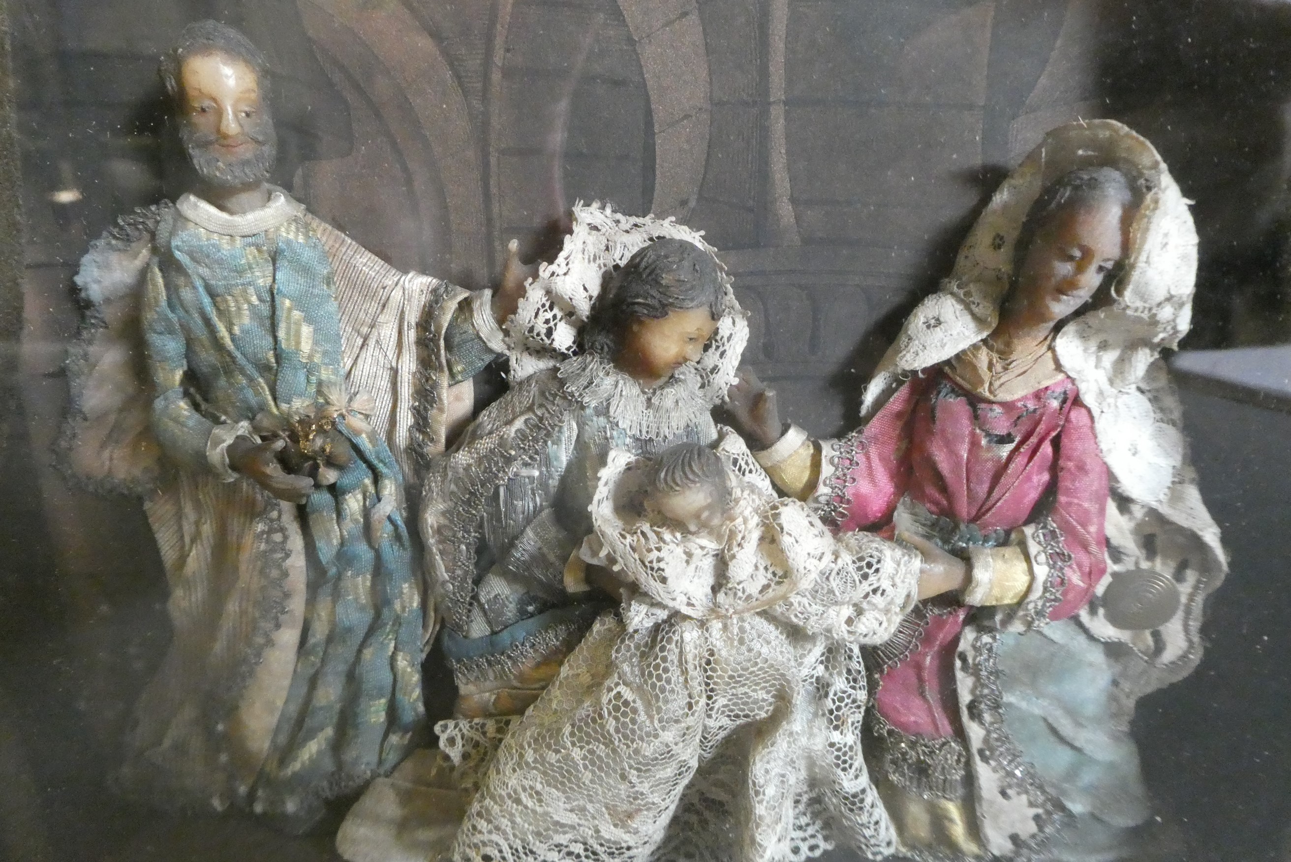 A wax nativity diorama, the figures with moulded and painted wax heads ...