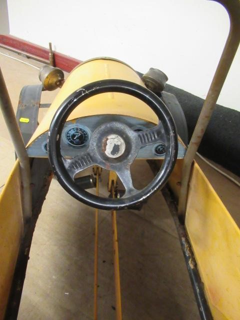 A vintage brum pedal car, of metal construction with classic yellow ...