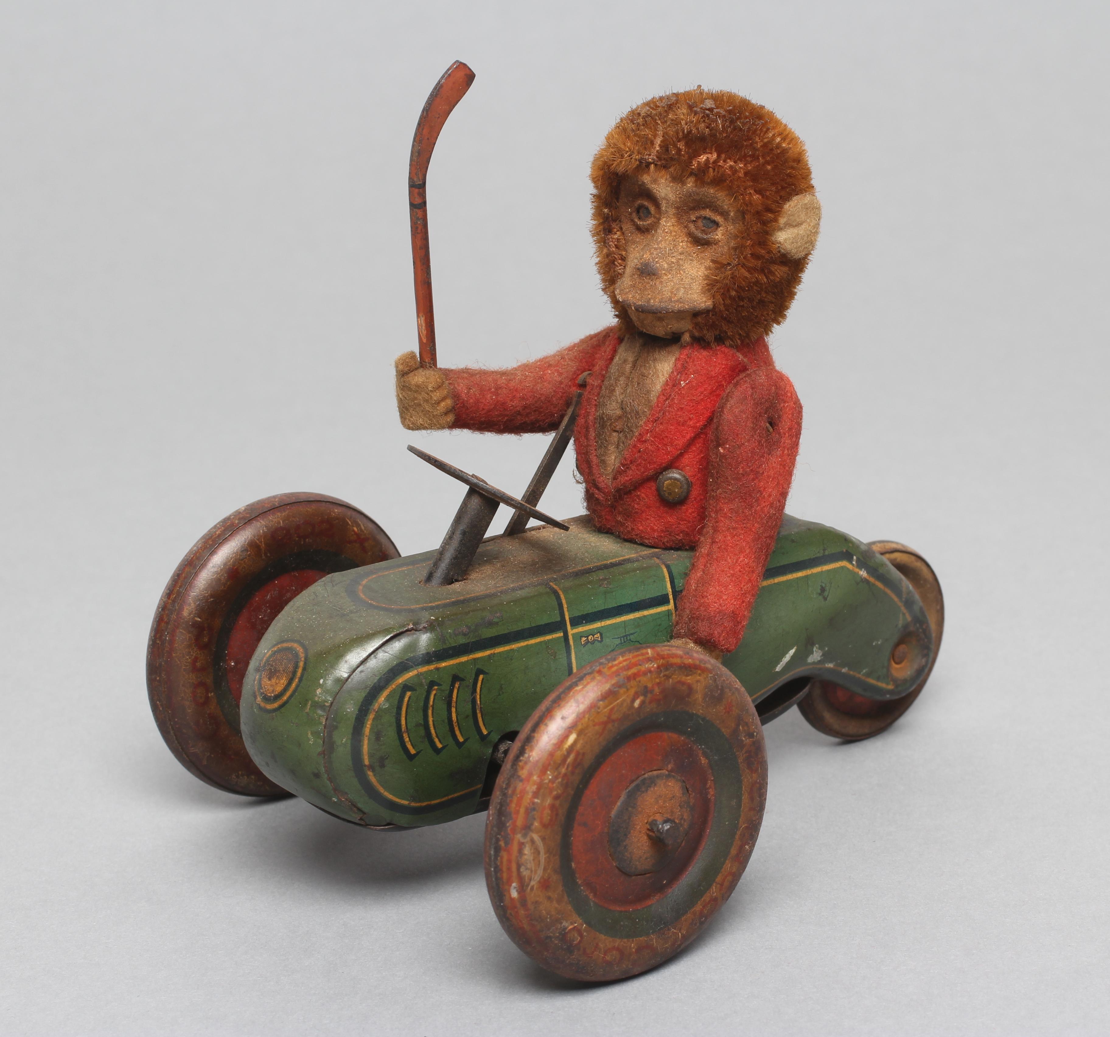Early schuco clockwork monkey in tricycle with hockey stick | Hartleys ...