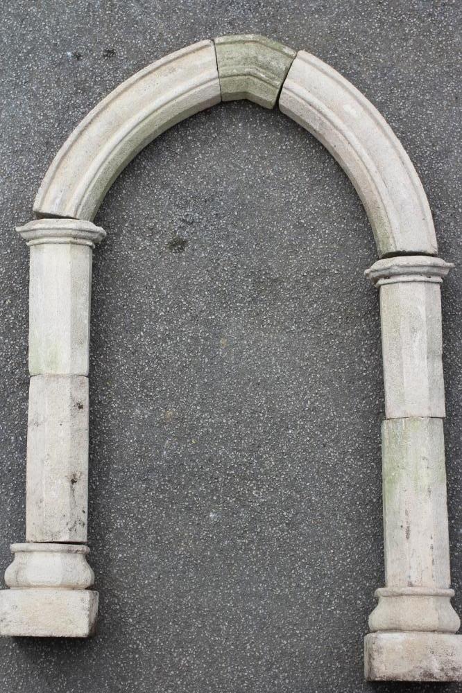 A cast stone gothic arch, the octagonal supports on ogee moulded base ...
