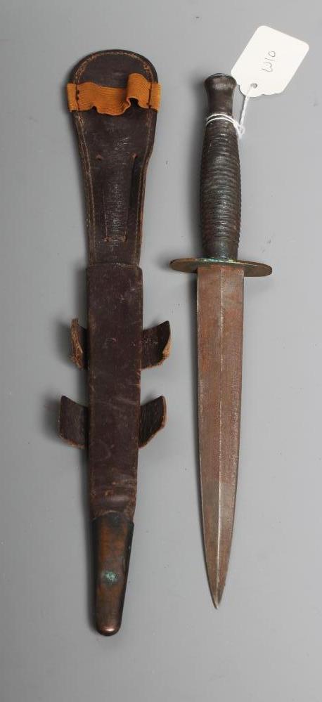 A fairbairn & sykes dagger with 7" double edged blade, brass crossguard ...