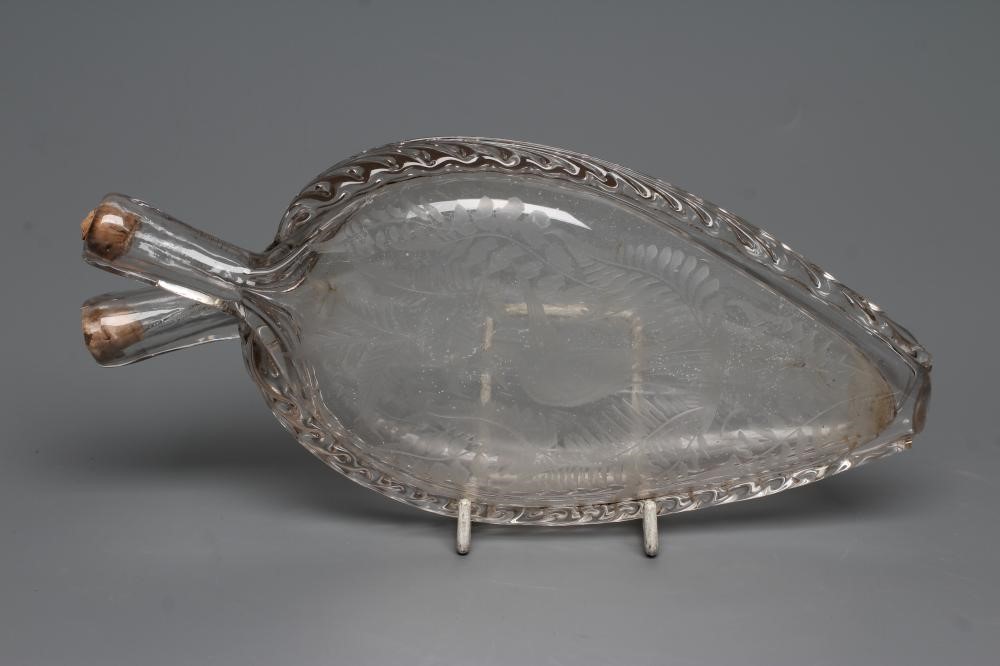 A victorian eliptical glass flask with double spout and applied prunted ...
