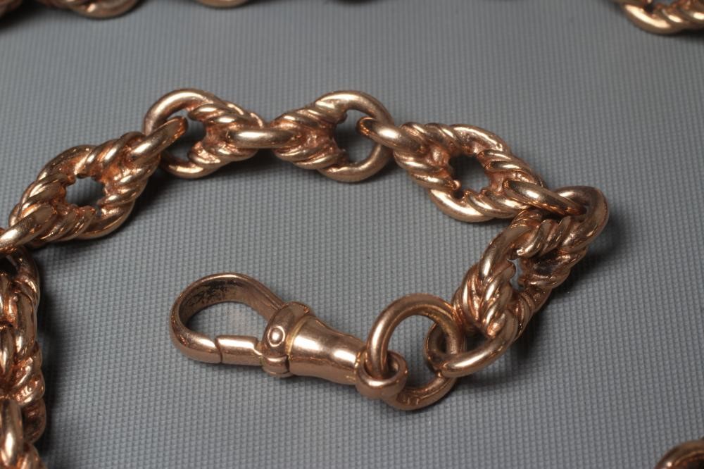 A fancy link double albert chain with two dog-clip fasteners and t bar ...