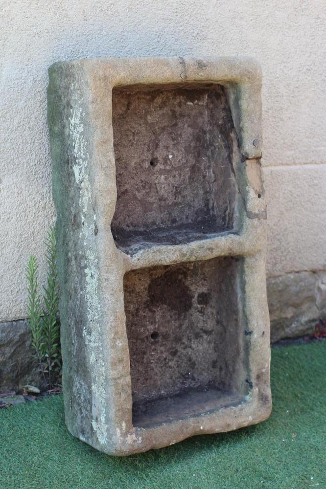 A sandstone trough of rough-hewn oblong form with central division. 34 ...
