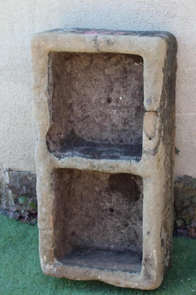 A sandstone trough of rough-hewn oblong form with central division. 34 ...