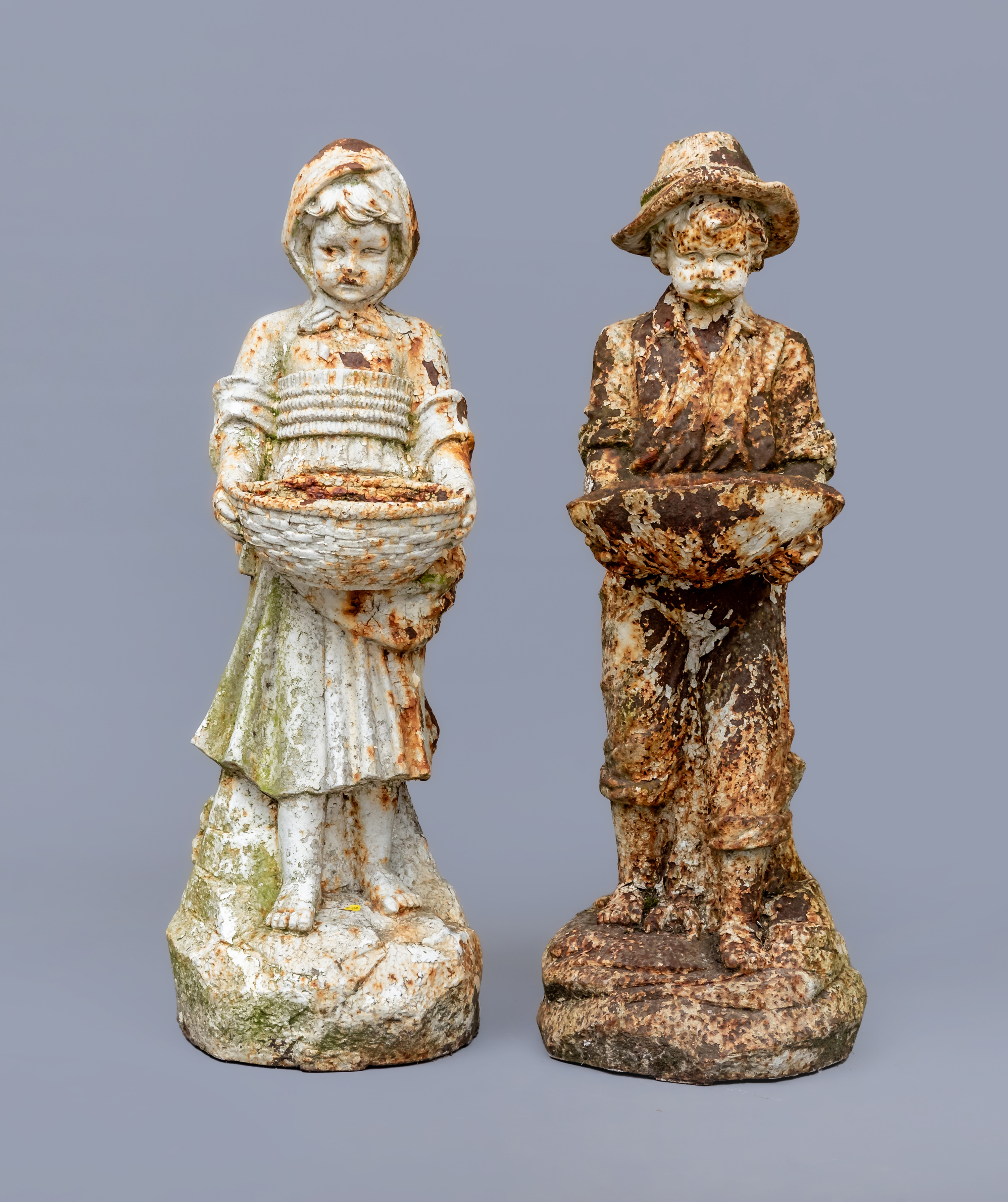 A pair of cast iron figures, c.1900, of a dutch boy and girl, each ...