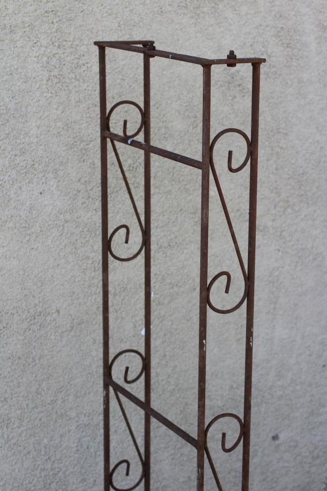 A wrought iron rose arch, modern, the openwork rounded arch with spear ...