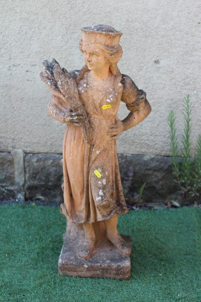 A cast red stone female figure allegorical of autumn, modelled standing ...