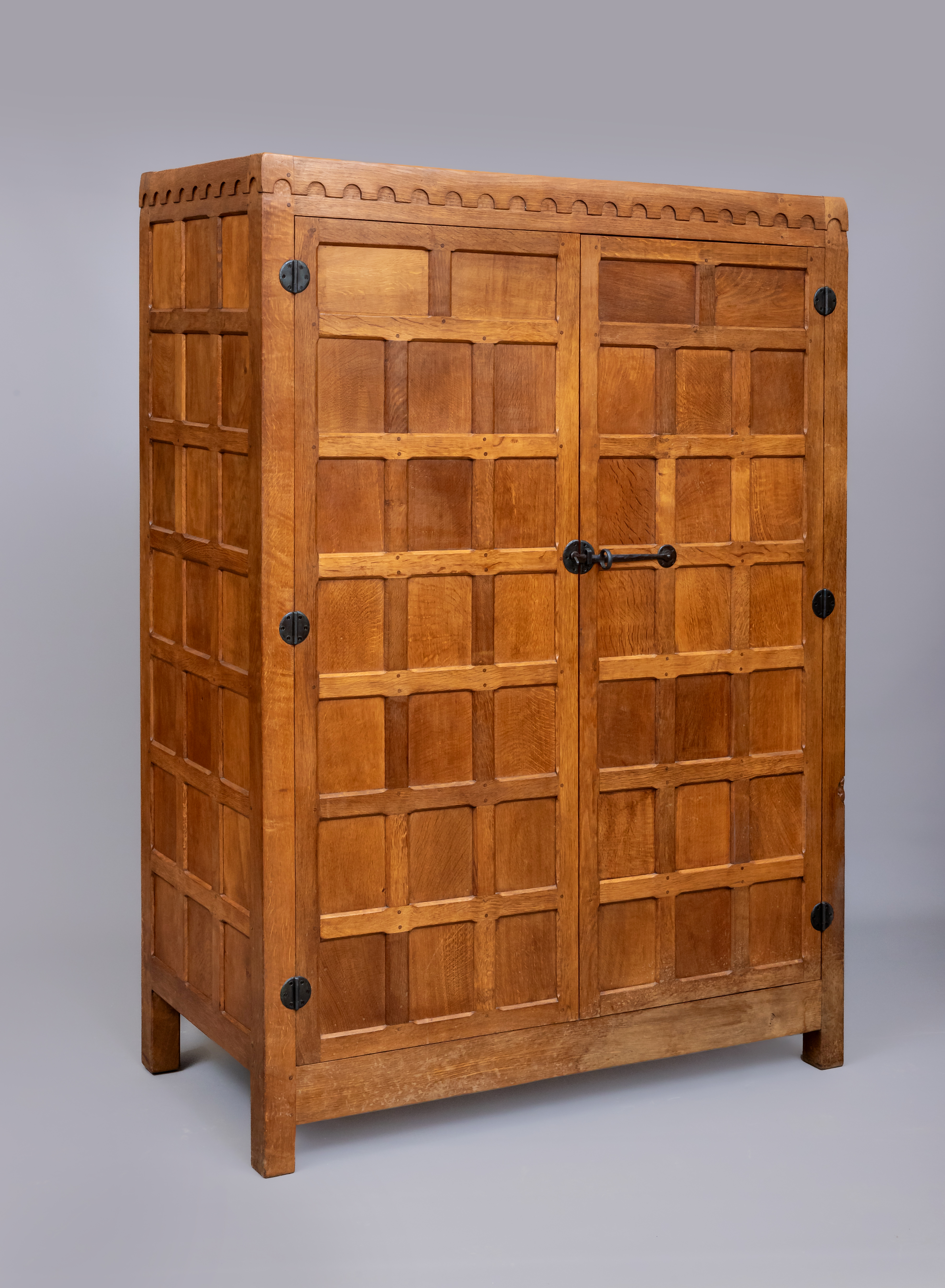 A robert thompson adzed oak double wardrobe of multi-panelled form with ...