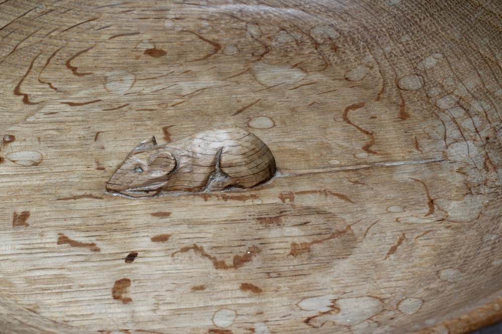 A robert thompson adzed oak fruit bowl of shallow circular form with ...