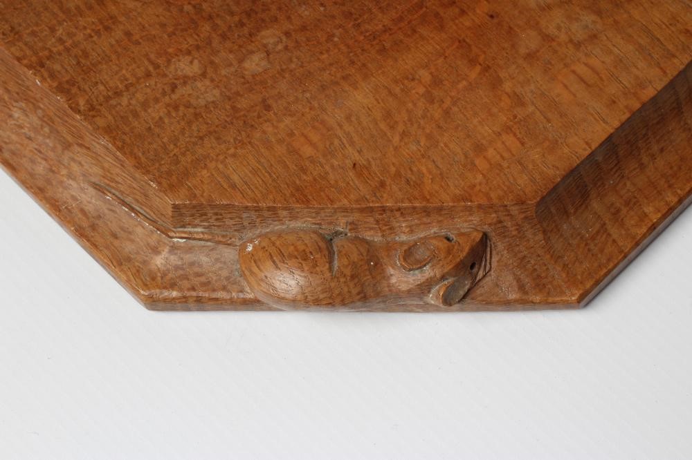 A robert thompson adzed oak bread board of canted oblong form, the ...