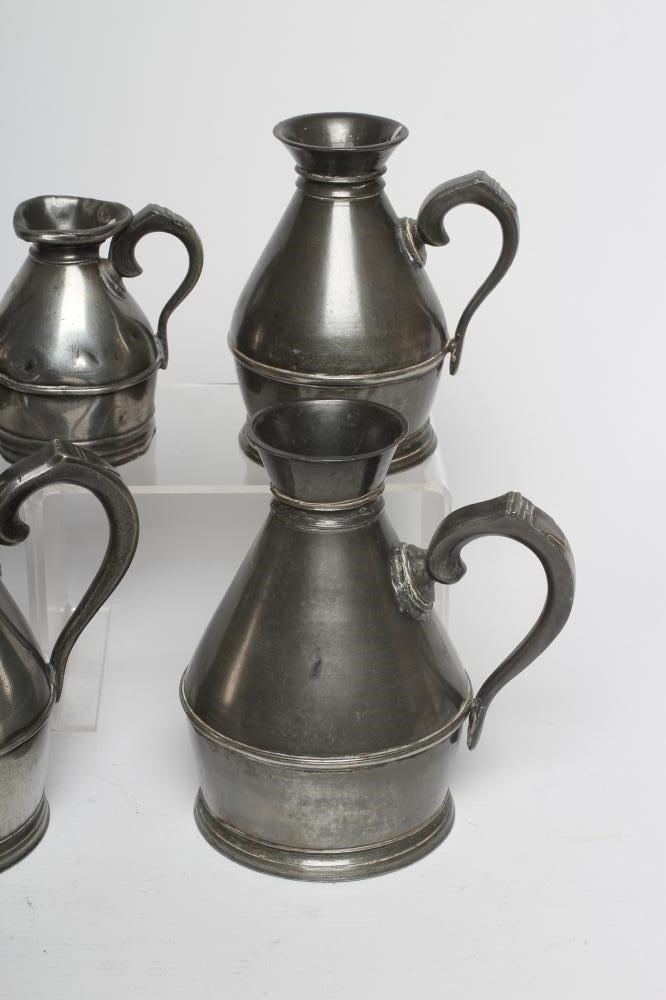 Nine various pewter haystack measures, including a quart, two pints ...