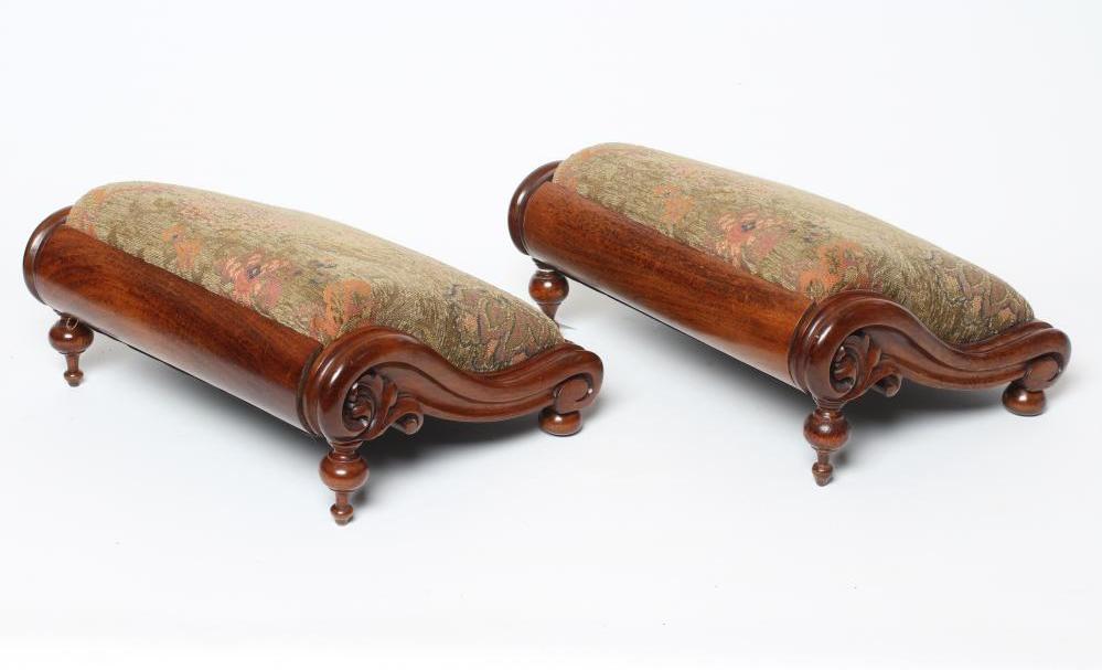 A pair of victorian walnut show frame footstools of sloping oblong form ...