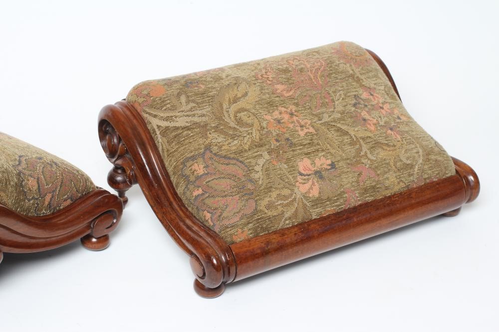 A pair of victorian walnut show frame footstools of sloping oblong form ...