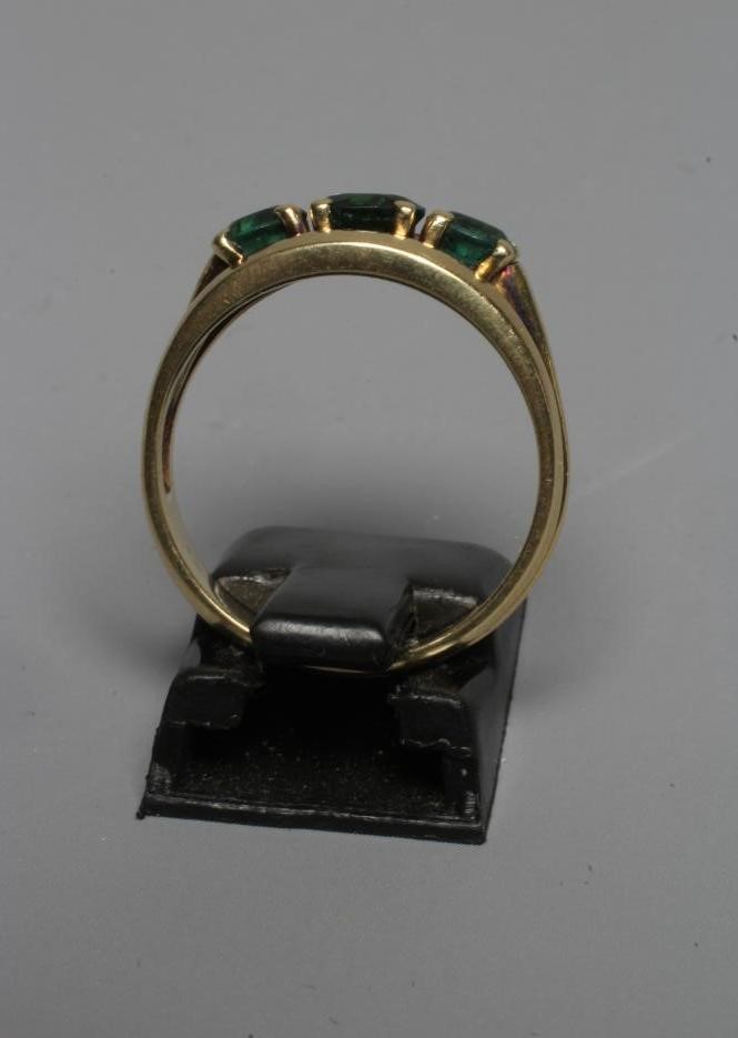 A three stone green tourmaline ring, the circular facet cut stones claw ...