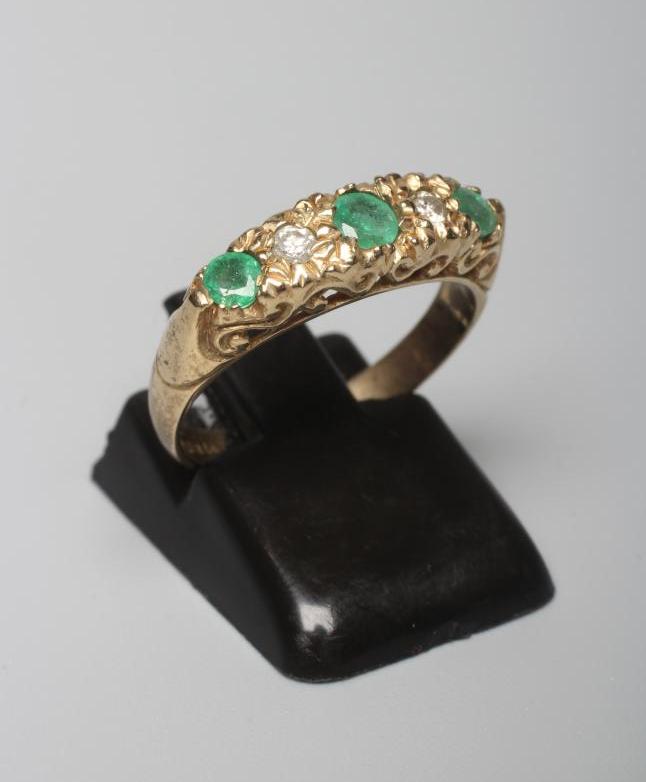 An emerald and diamond half hoop ring, the three circular facet cut ...