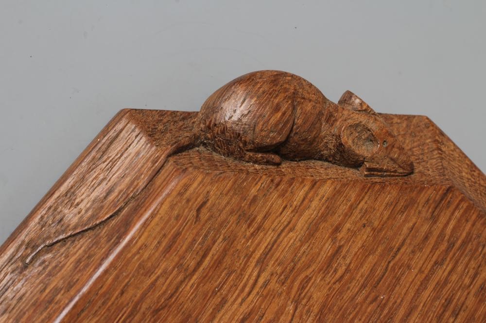 A robert thompson adzed oak bread board of canted oblong form, the ...