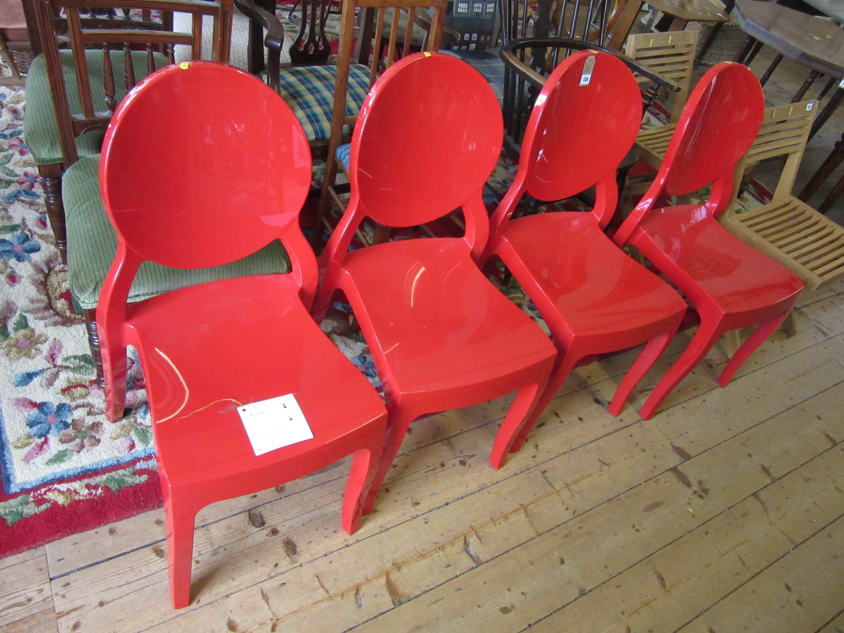 Four red plastic stacking chairs | Hartleys Auctioneers & Valuers