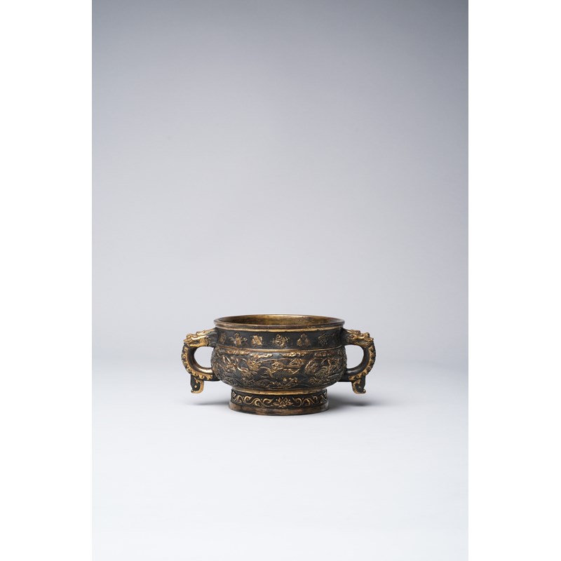 A heavily-cast chinese parcel-gilt copper alloy 'mythical beast ...