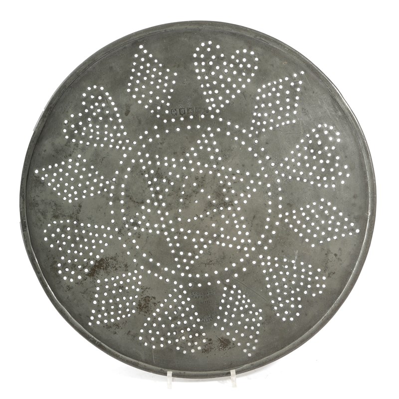A large and impressively decorated pewter strainer dish | Woolley and ...