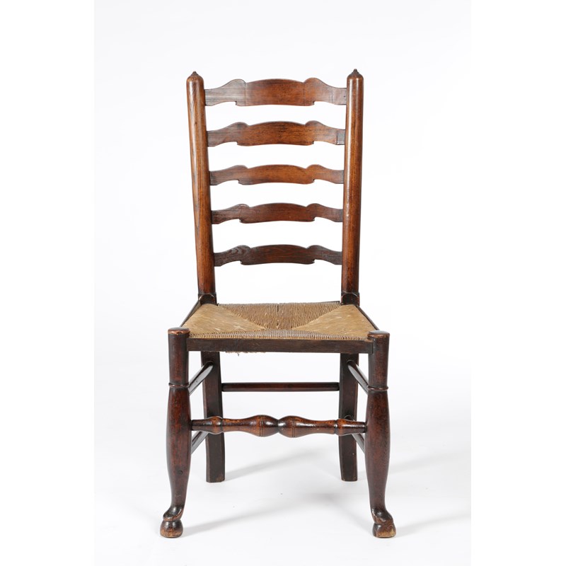 A harlequin set of eight ash ladder back dining chairs | Woolley and Wallis