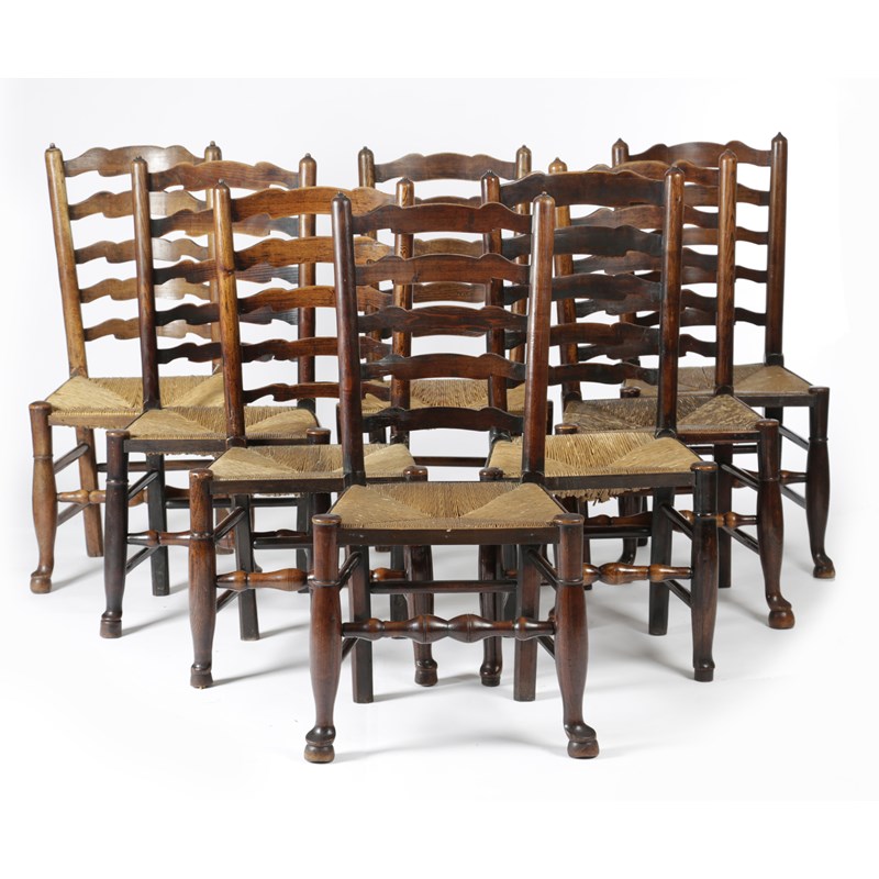 A harlequin set of eight ash ladder back dining chairs | Woolley and Wallis
