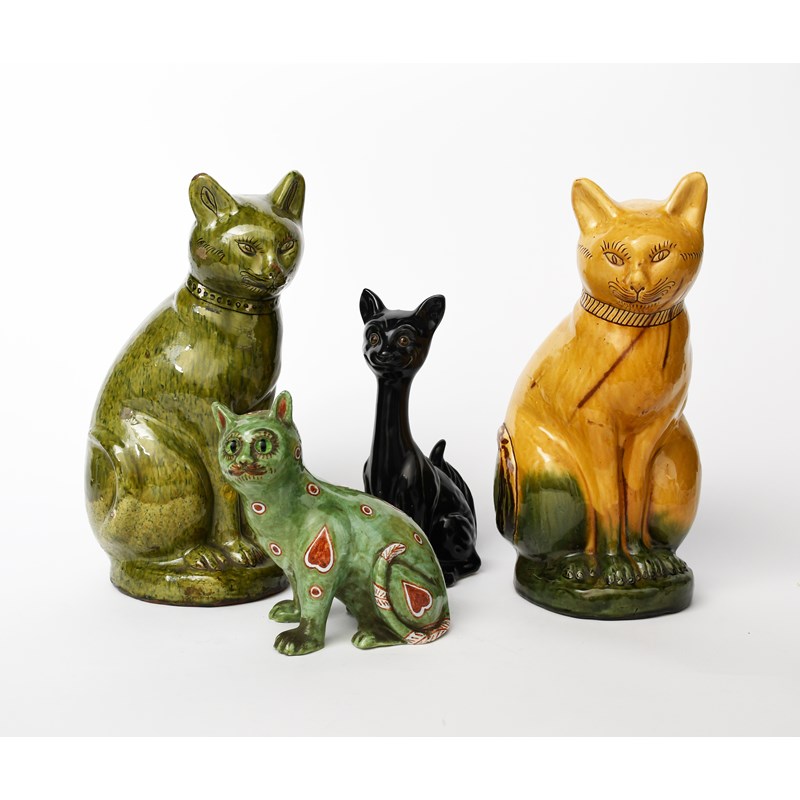 Two large ewenny pottery cats, one dated 1905, each modelled seated, one glazed yellow, the ...