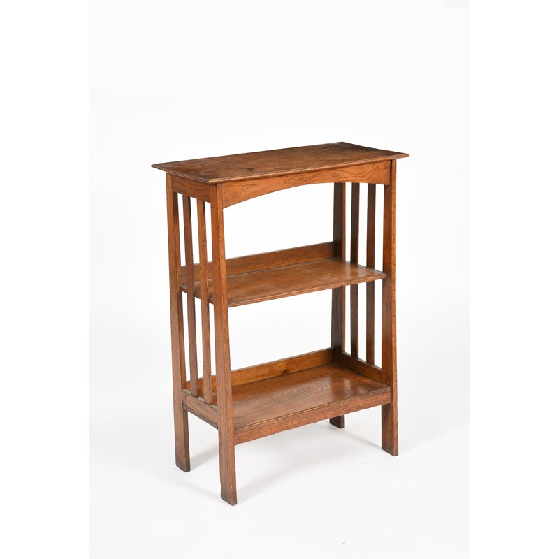 An oak bookshelf, rectangular with splat ends, | Woolley and Wallis