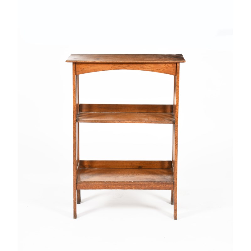 An oak bookshelf, rectangular with splat ends, | Woolley and Wallis