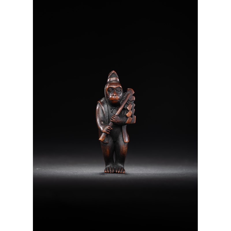 A japanese wood netsuke of a monkey dressed as a shinto priest ...