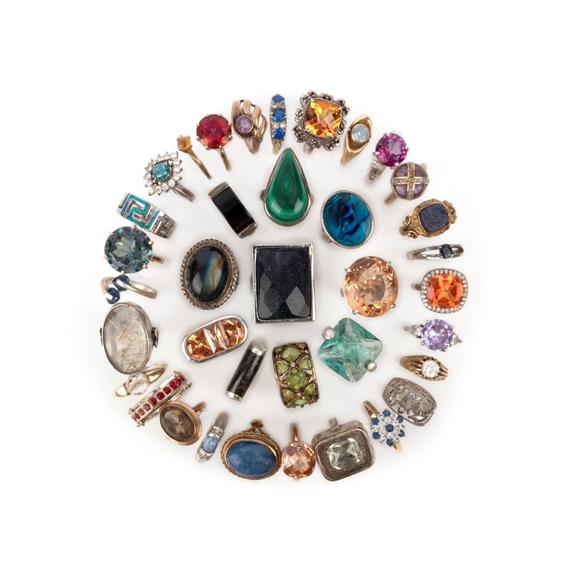 A collection of thirty seven gem-set rings, variously set with natural ...