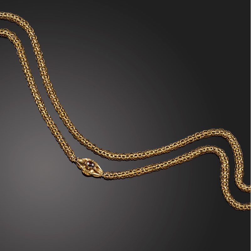 An early 19th century gold long guard chain, of fancy linking, with a ...