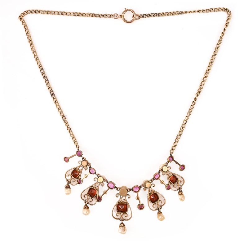 A pink sapphire, garnet and cultured pearl necklace | Woolley and Wallis