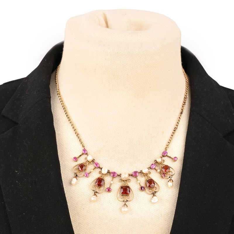 A pink sapphire, garnet and cultured pearl necklace | Woolley and Wallis