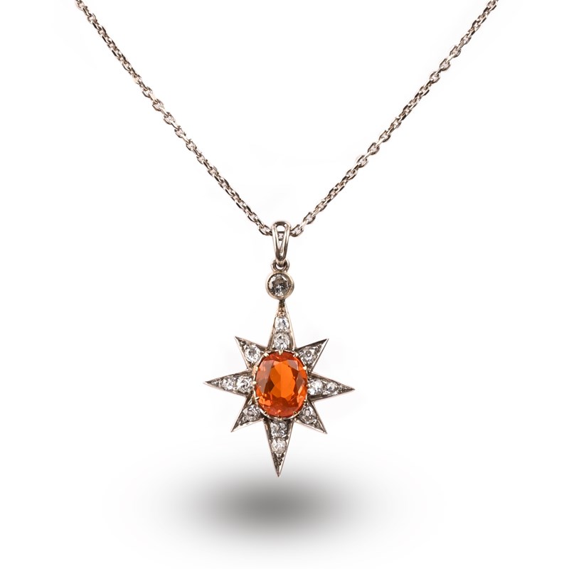 A fire opal and diamond pendant necklace | Woolley and Wallis