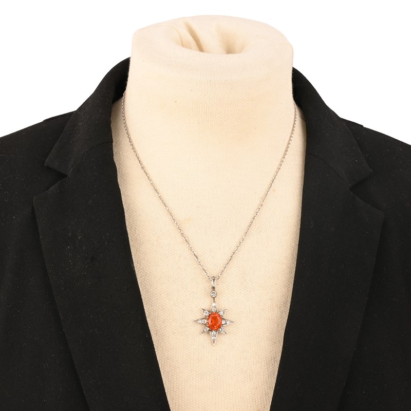 A fire opal and diamond pendant necklace | Woolley and Wallis