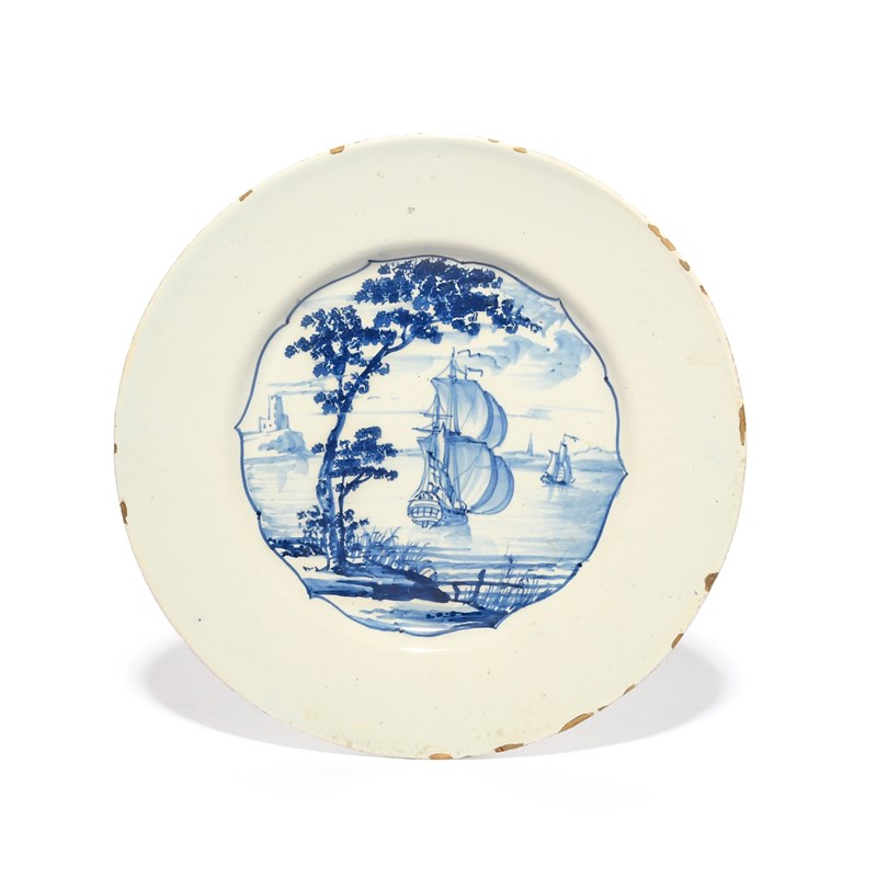 A rare bristol delftware plate, c.1740, the well painted in blue with a ...
