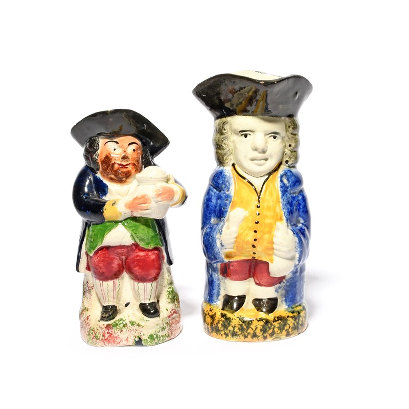 A yorkshire standing toby jug, c.1810-20, holding a glass and bottle ...