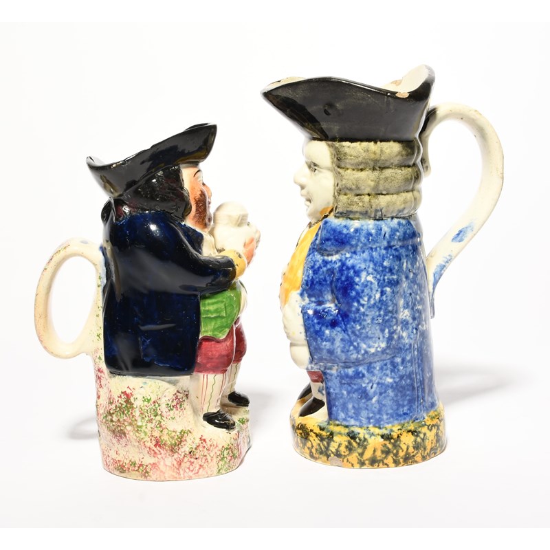 A yorkshire standing toby jug, c.1810-20, holding a glass and bottle ...