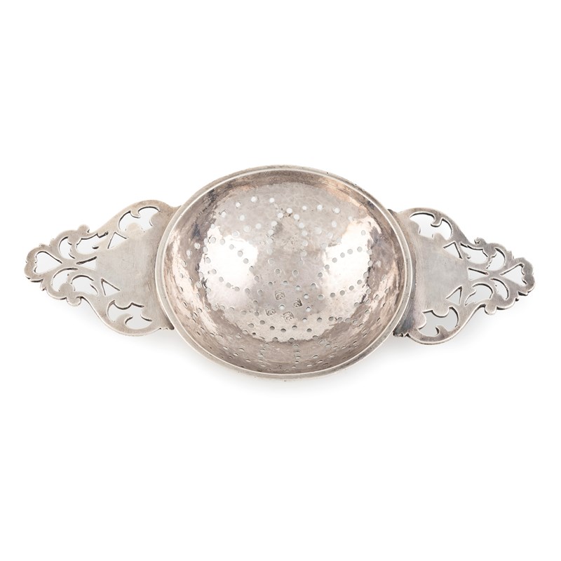 An early-18th century silver lemon strainer,marked four times with ...