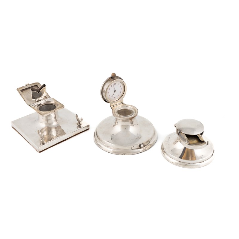 Three silver capstan inkwells/stamp holders, | Woolley and Wallis