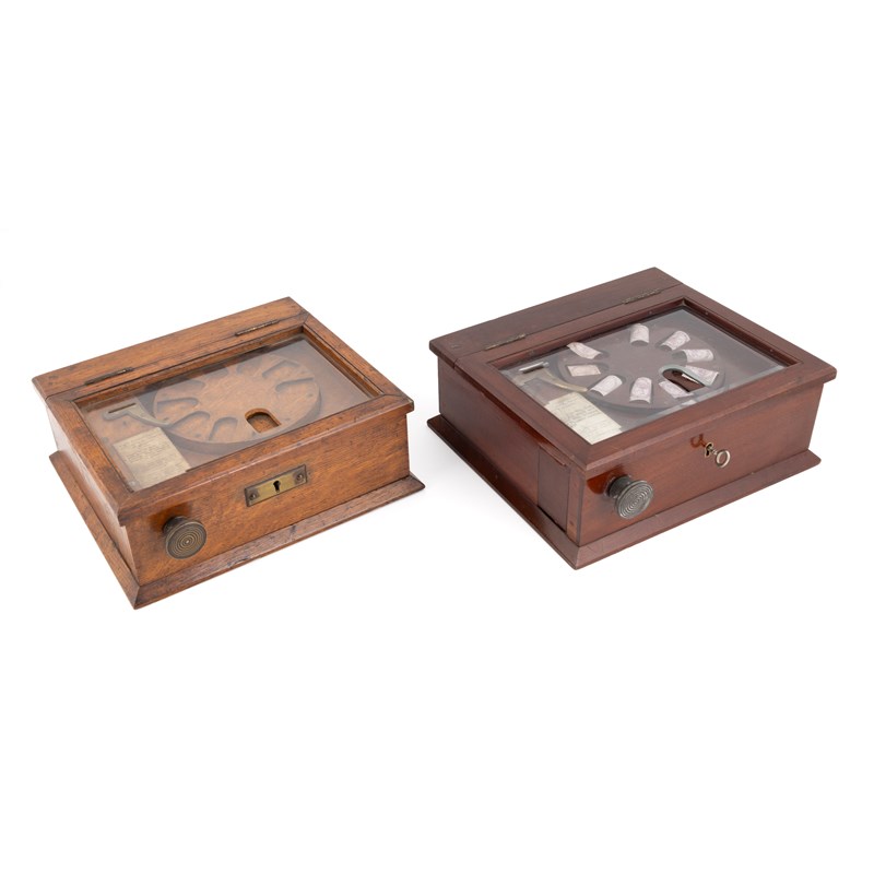 Two late-19th century oak coin-operated stamp dispensers, | Woolley and ...