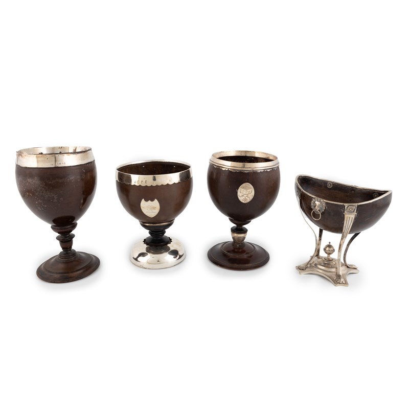 A collection of four silver-mounted coconut cups, | Woolley and Wallis
